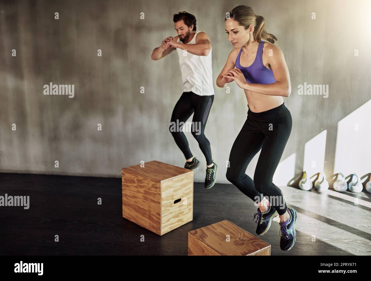 Nothing good ever came easy. two young people box jumping as part of ...
