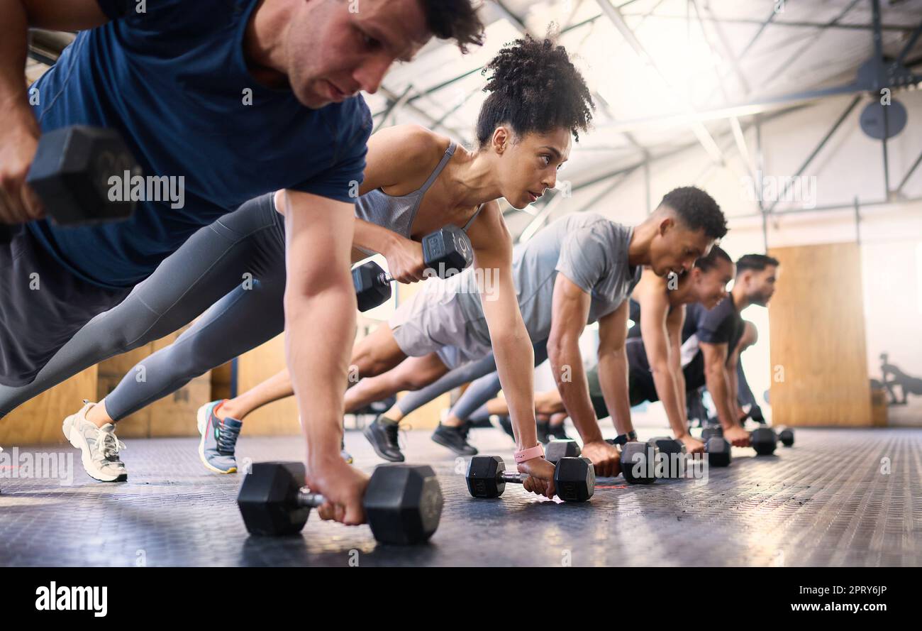 Strong, fitness and gym people with dumbbell teamwork training or ...