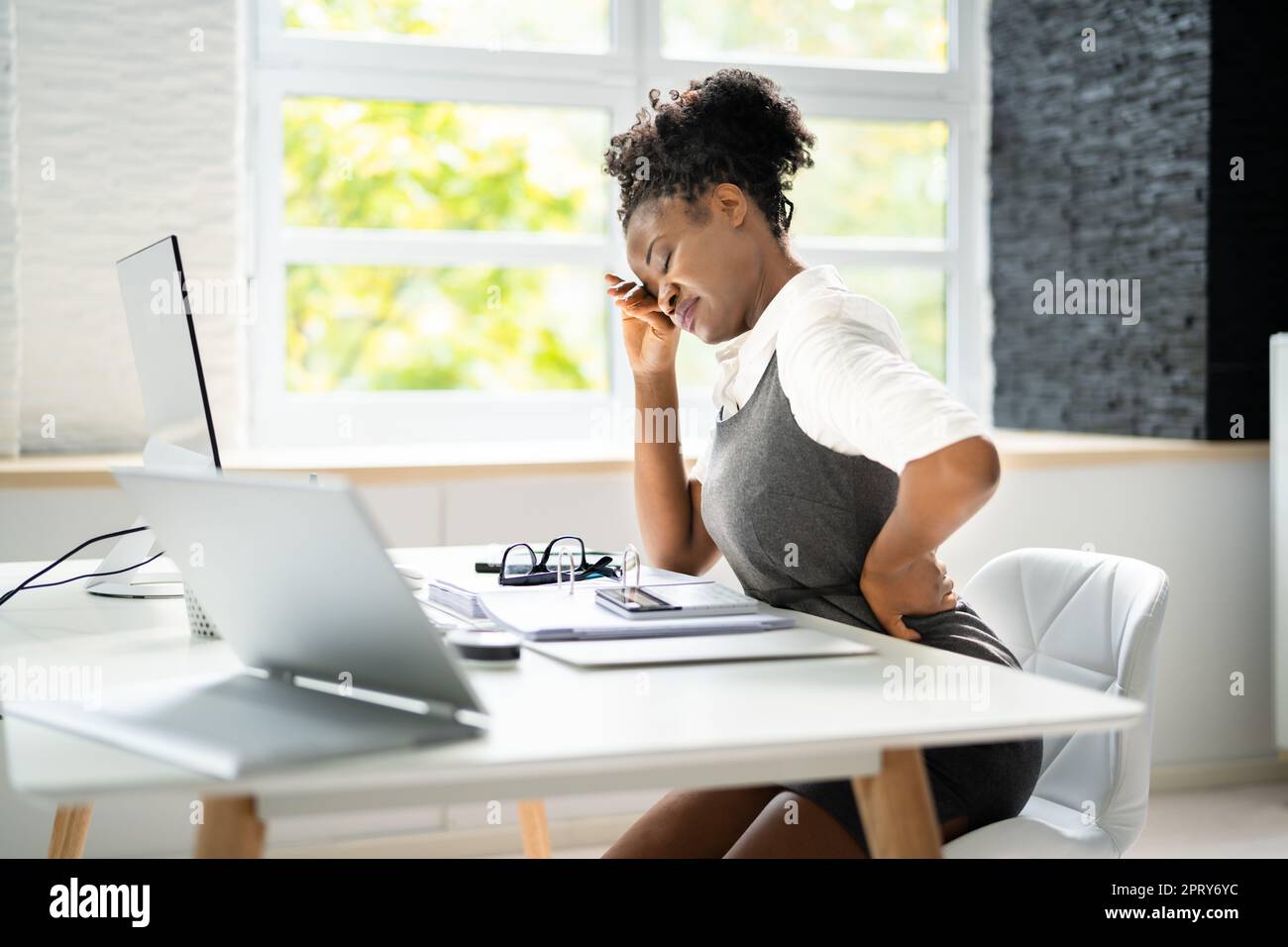Back Pain Bad Posture Woman Sitting In Office Stock Photo - Alamy