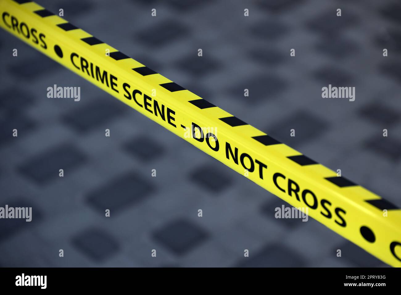 Crime scene tape for covering the area cordon. Yellow tape with blurred ...