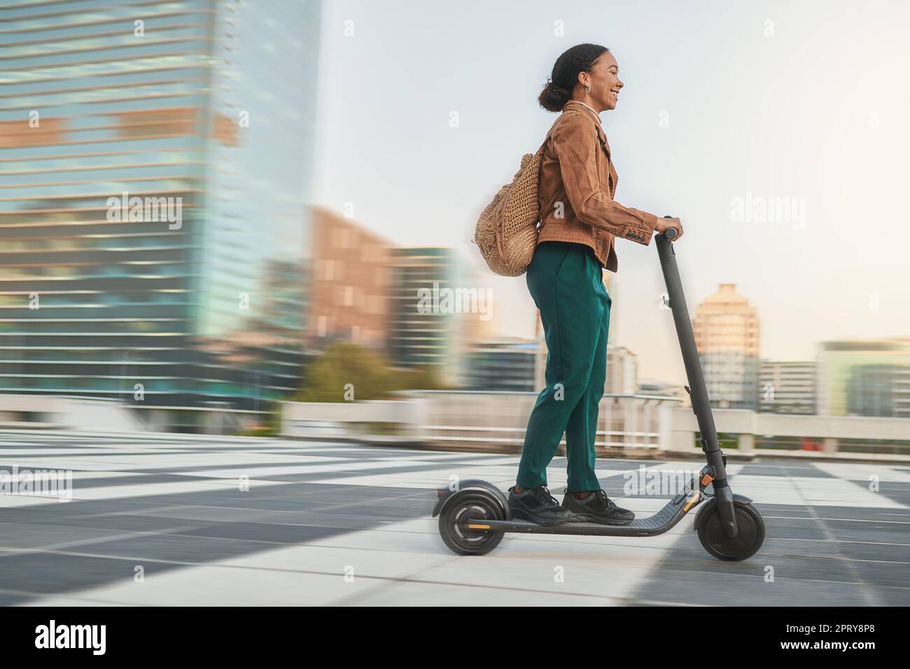 Electric scooter, travel and black woman with eco friendly transport ...