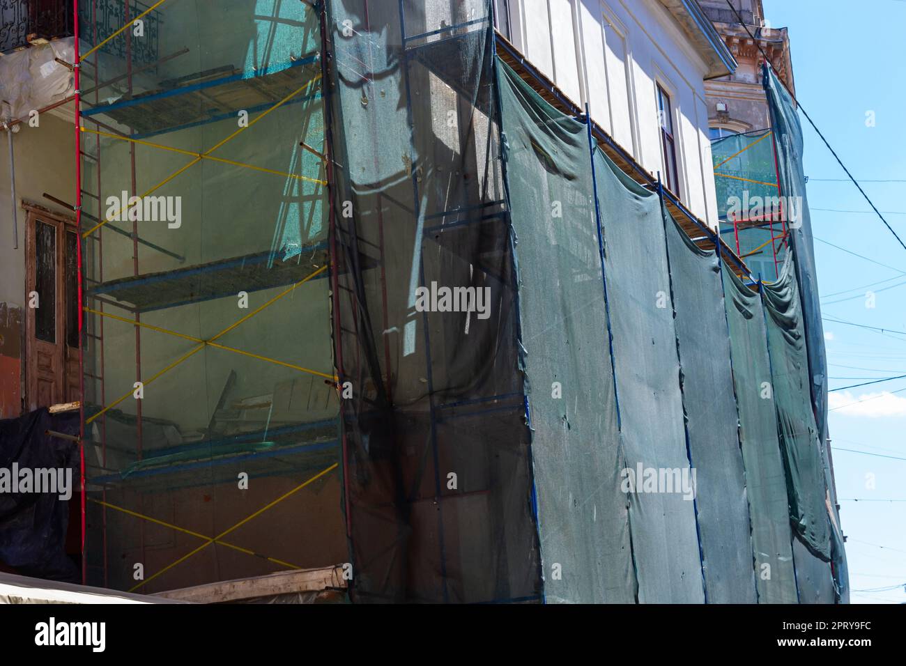 Restoration of the building. Scaffolding and protective green building ...