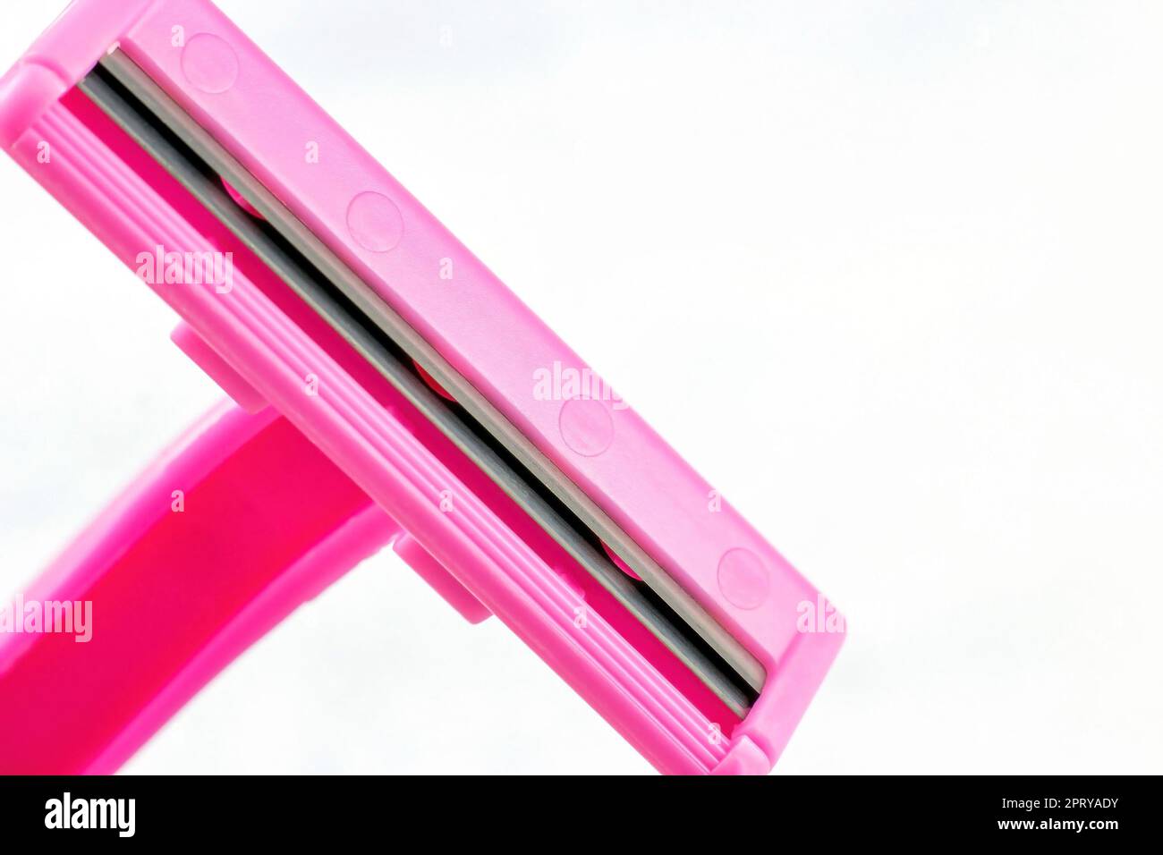 Pink disposable woman razor on white background close up. Hair removing ...