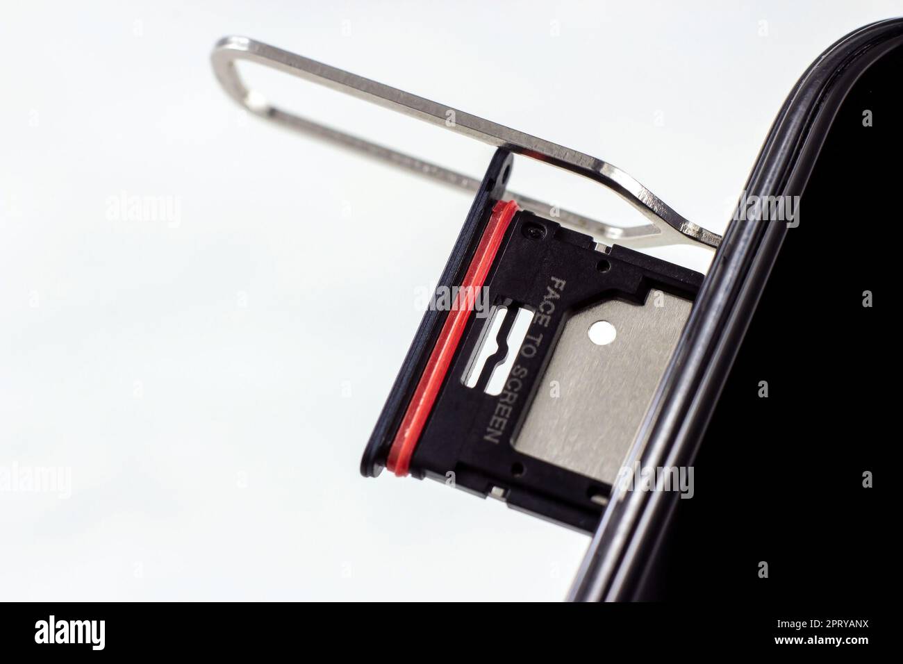 Pulling out the phone sim card tray from the smartphone with the help ...