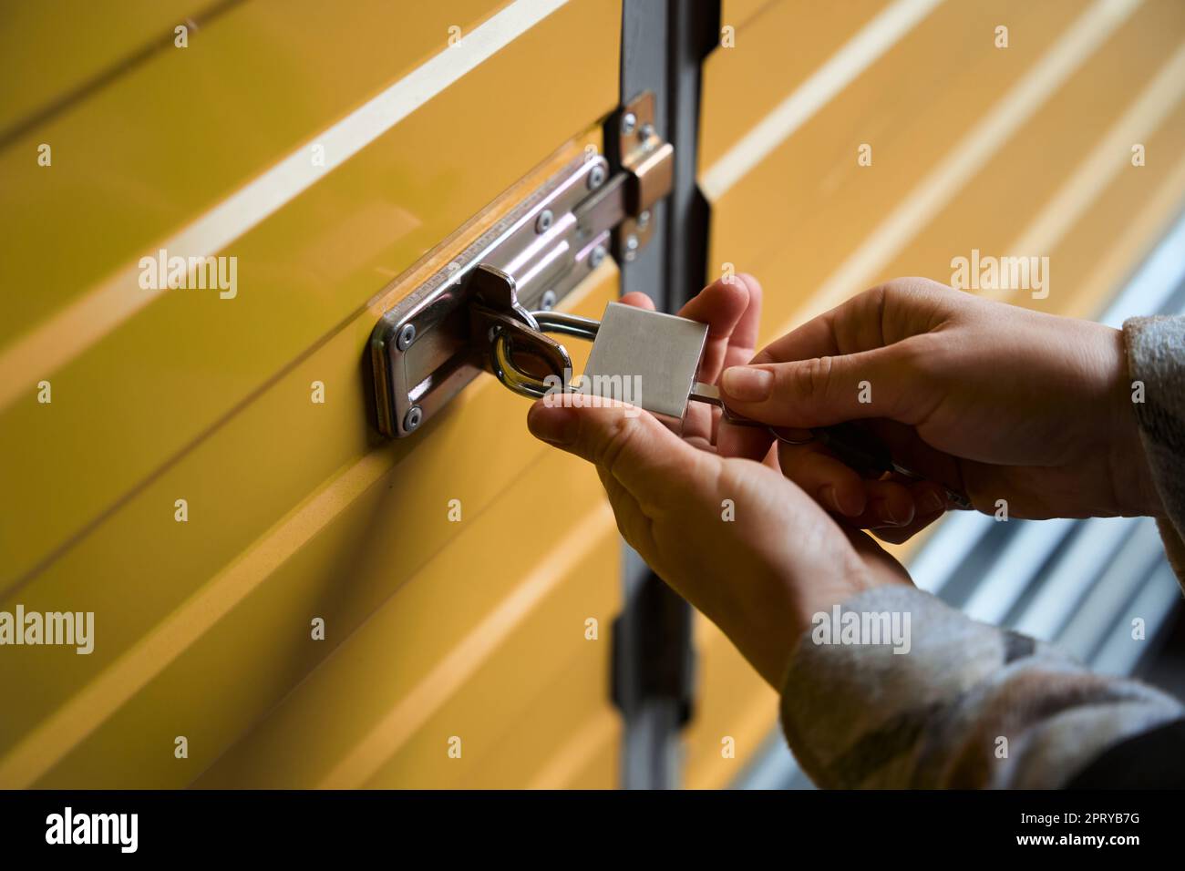 Close-up photo of a woman hands opening a lock Stock Photo - Alamy