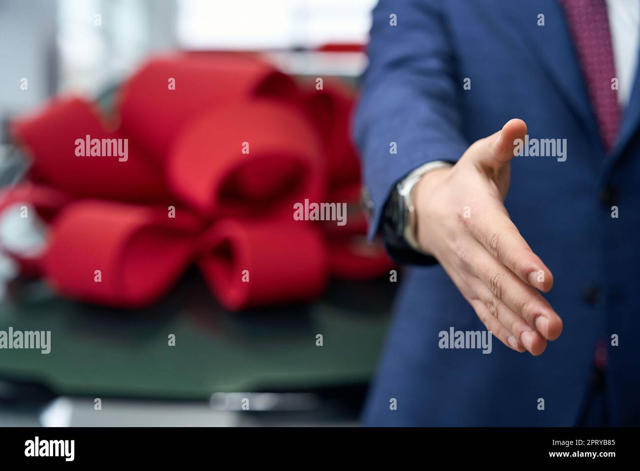 Man in a business suit extends his hand to greet Stock Photo - Alamy