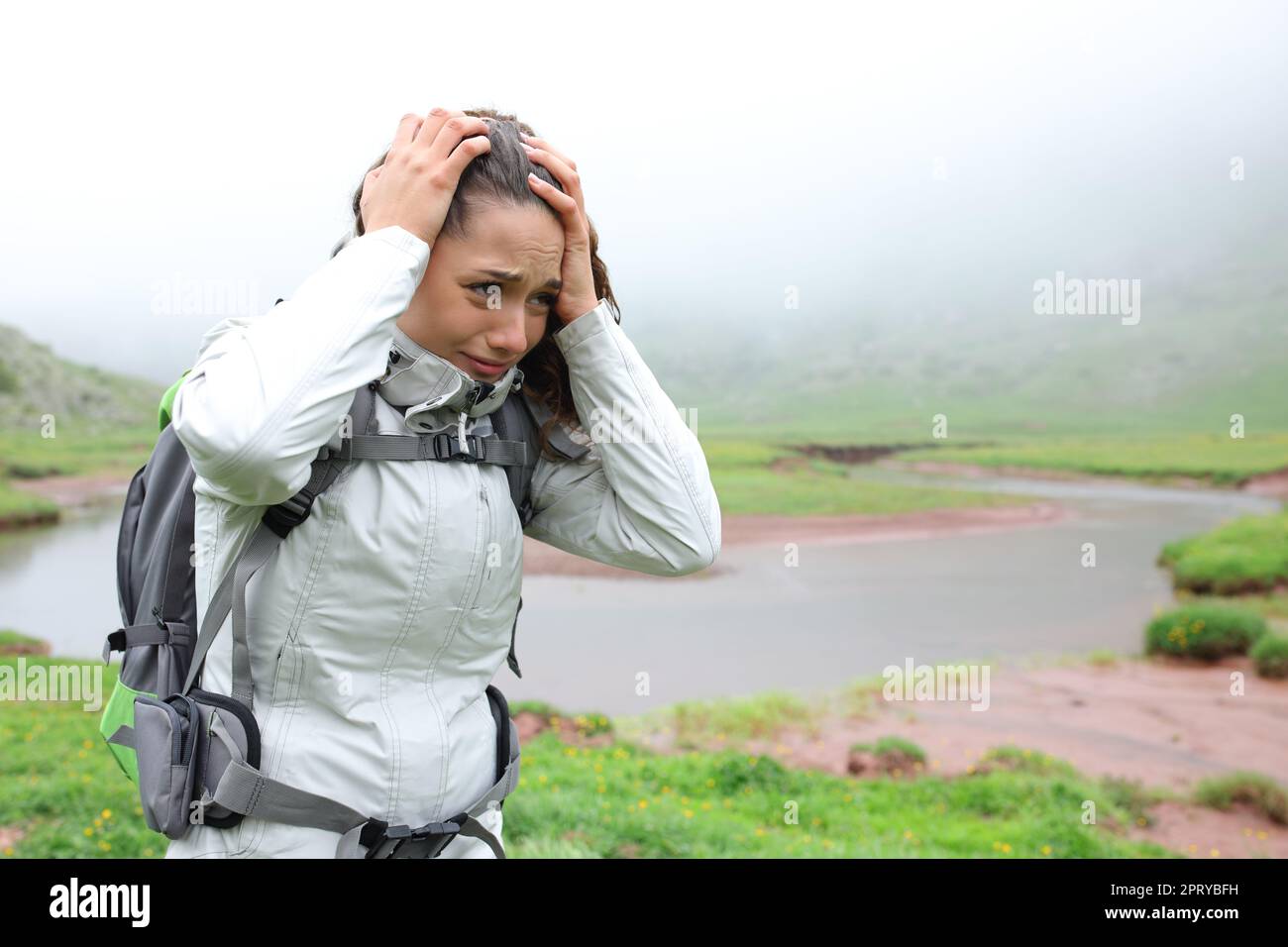 Worried hiker complaining alone walking in the mountain Stock Photo - Alamy