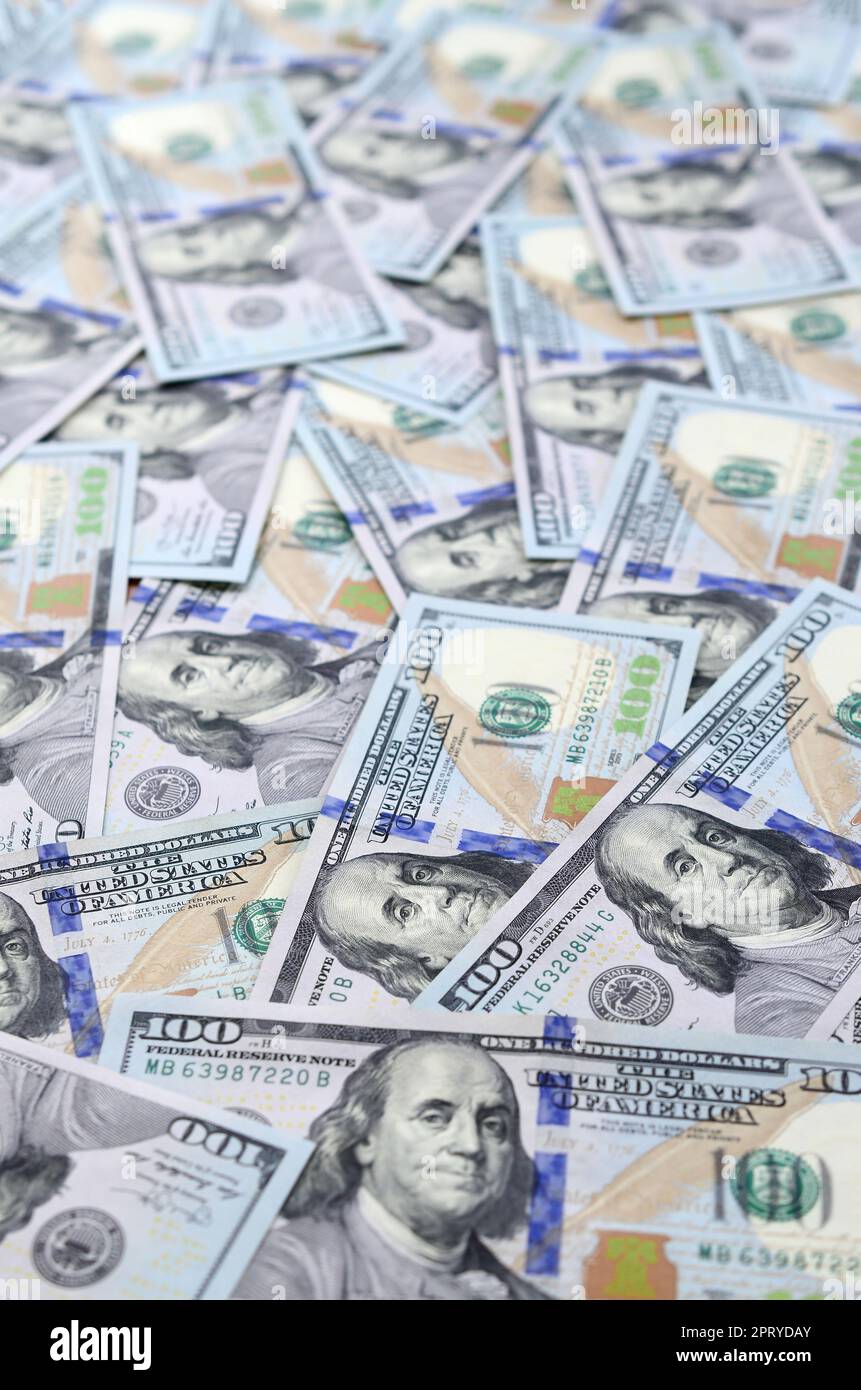 A large number of US dollar bills of a new design with a blue stripe in ...