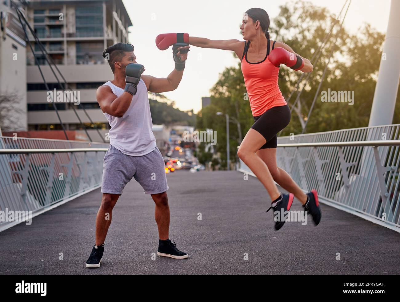 Showing great form. a young couple going through some kickboxing ...