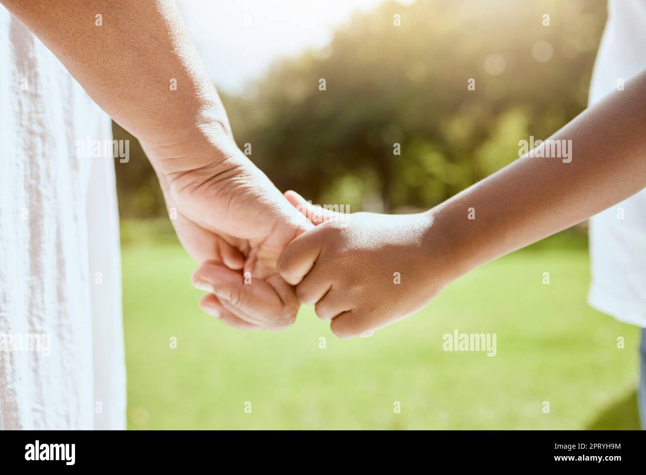 Park, family and parent holding hands with child bonding together ...