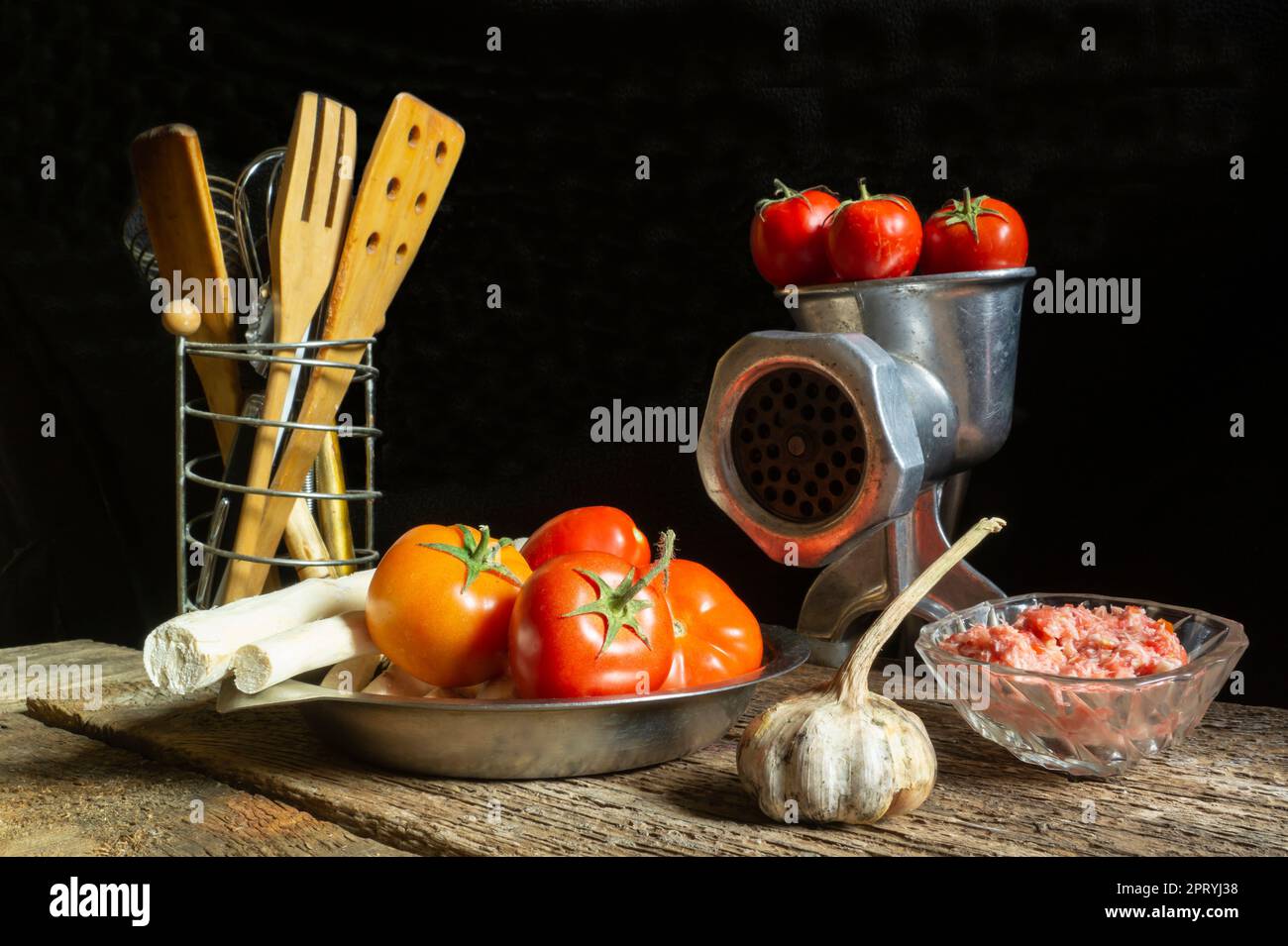 Still life with vegetables and kitchen utensils. Food on a black ...