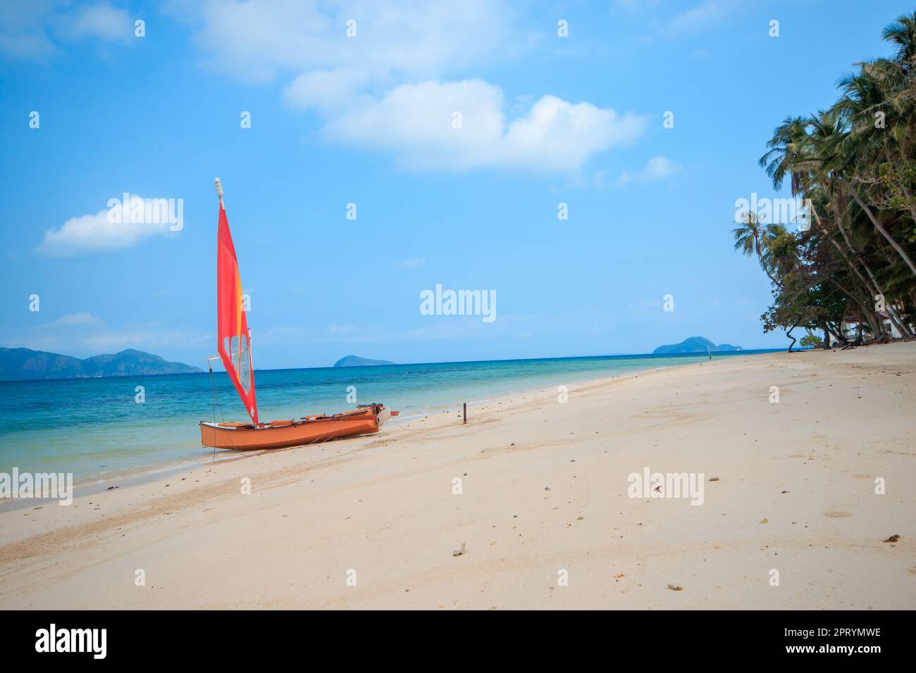 Orange sailboat on the beach Stock Photo - Alamy