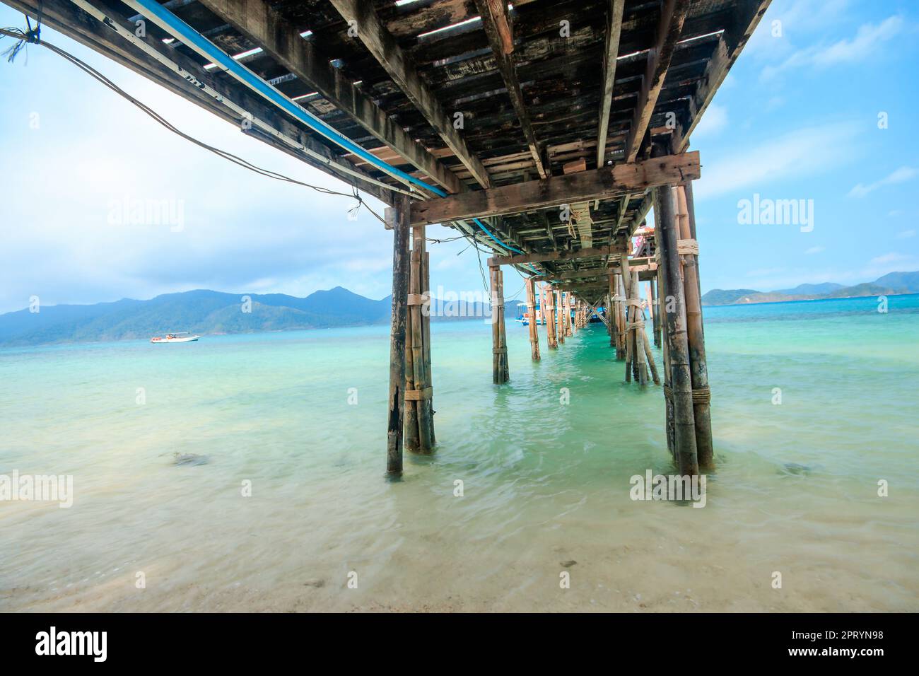 Wooden bridge extending into the sea Stock Photo - Alamy