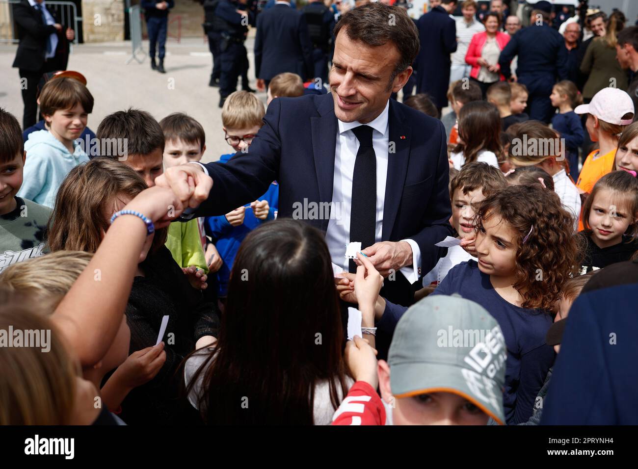 French President Emmanuel Macron meets children at a school in La Cluze ...
