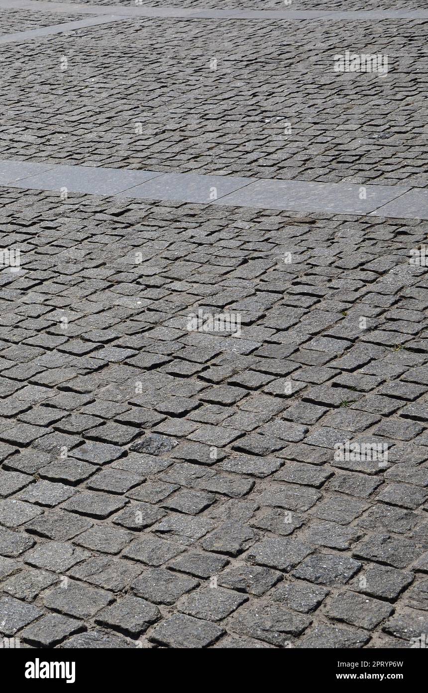 The texture of the paving slab (paving stones) of many small stones of ...