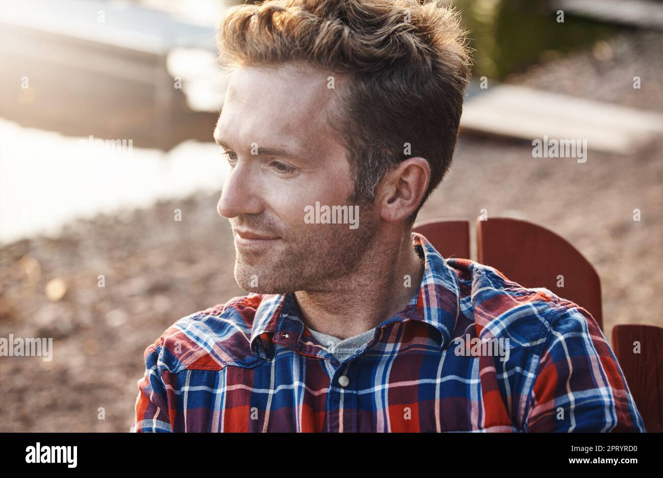 Just chill out and unwind. a handsome young man relaxing on a deck ...