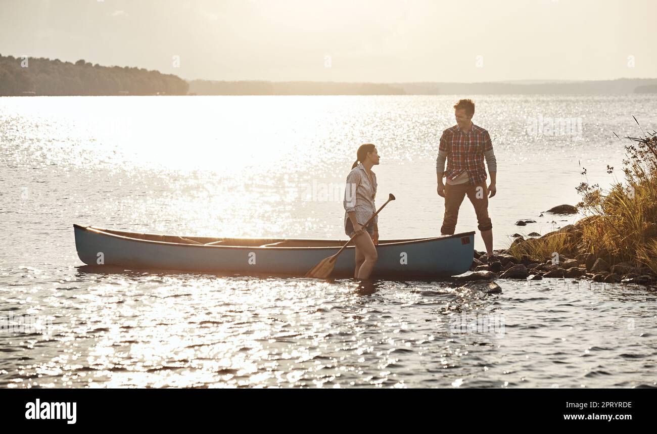Escape to the lake in a kayak. a young couple going for a canoe ride on ...