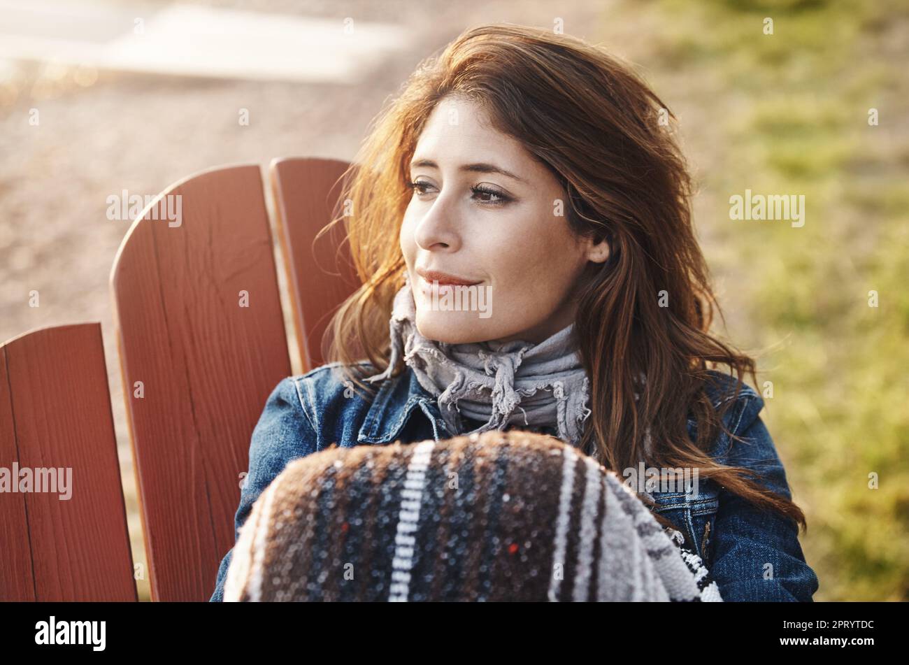 Now this is the good life. an attractive young woman relaxing on a deck ...