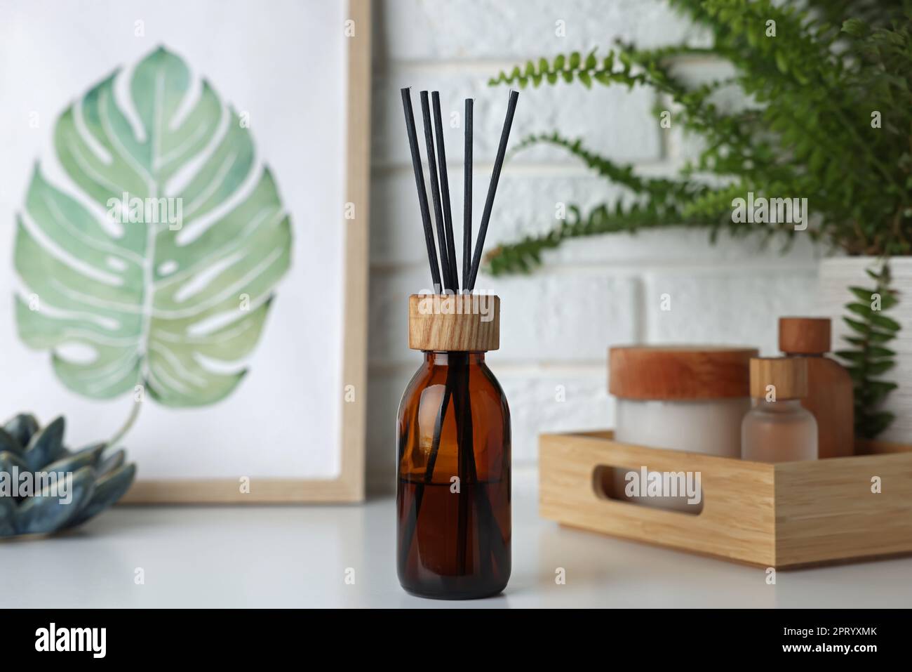 Air reed freshener, decor and cosmetic products on white table indoors ...