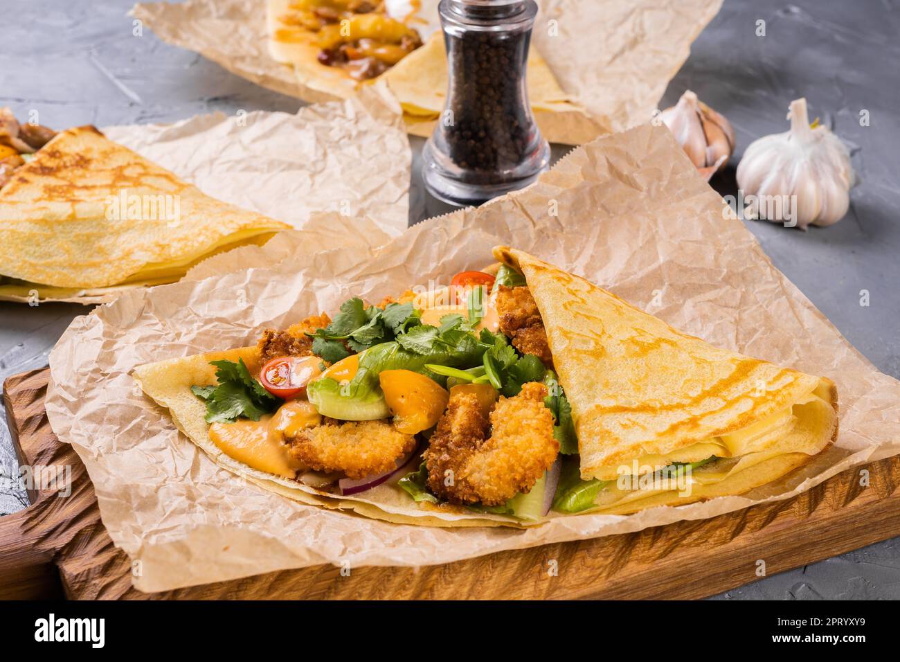 Pancake or crepe with fried shrimp tomatoes and vegetables Stock Photo - Alamy