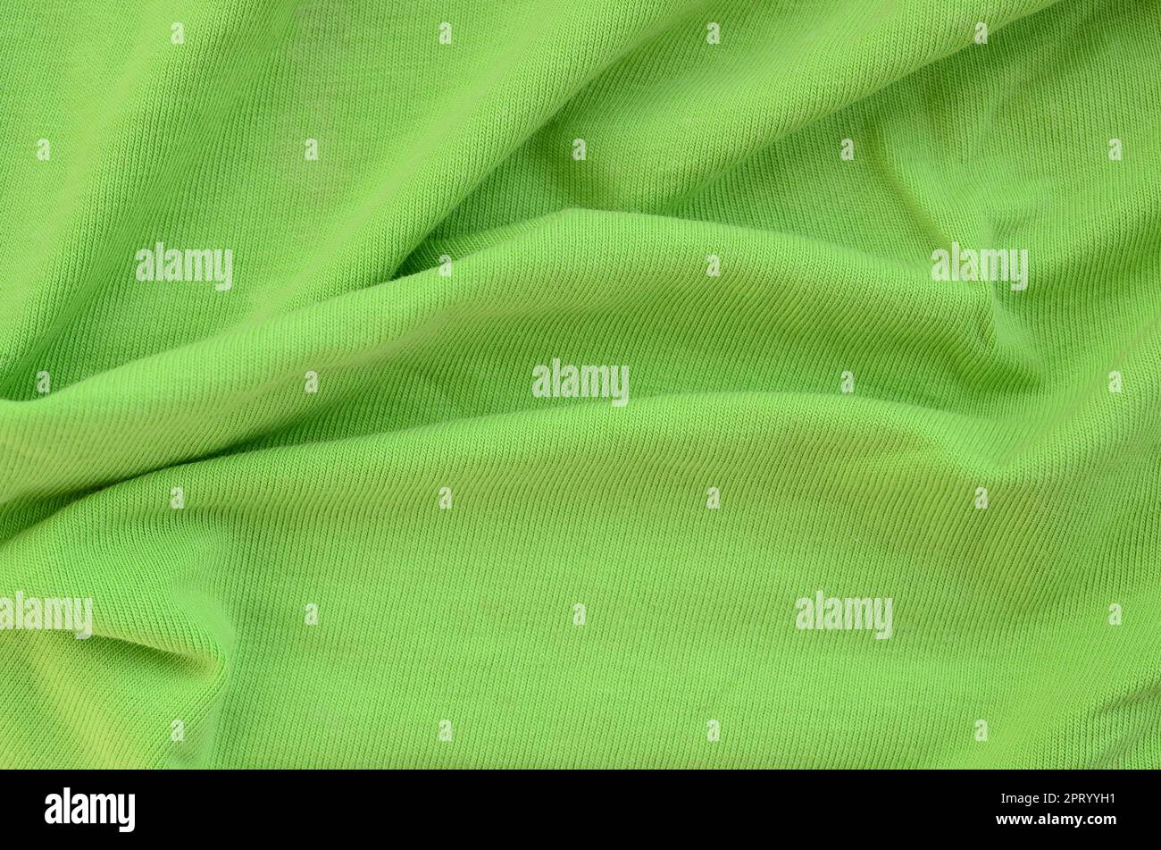 The texture of the fabric is bright green. Material for making shirts ...