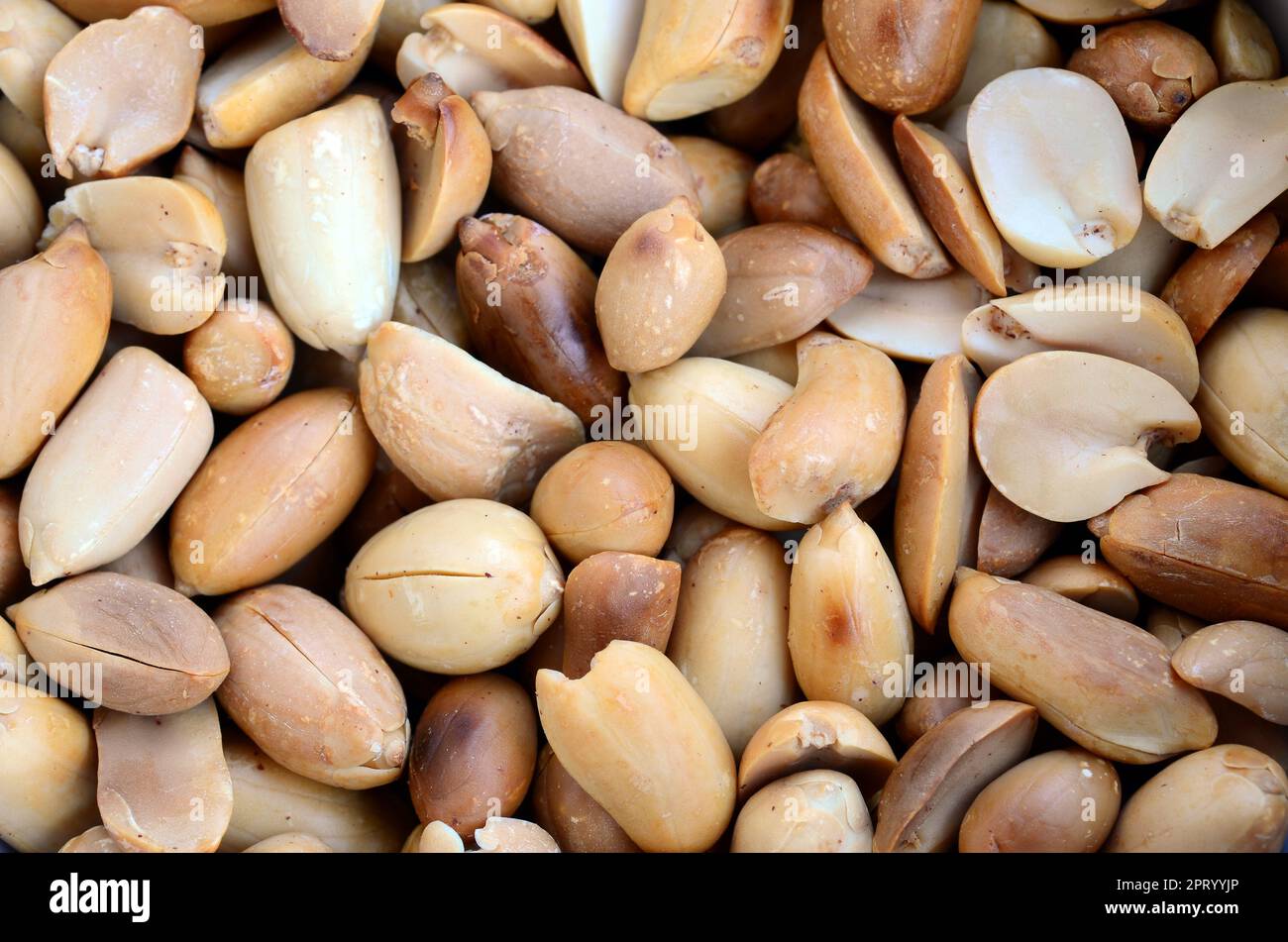 Peanut. A lot of small yellow nuts without peel. Background texture ...