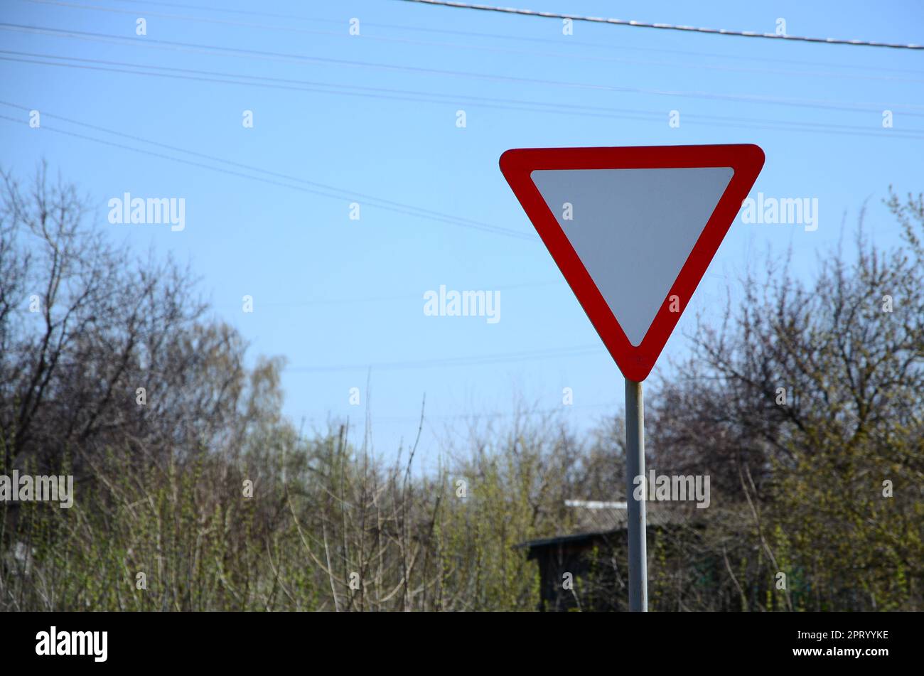 Traffic sign in the form of a white triangle. Give way Stock Photo - Alamy