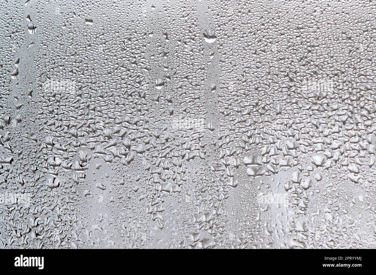 Texture of a drop of rain on a glass wet transparent background. Toned ...