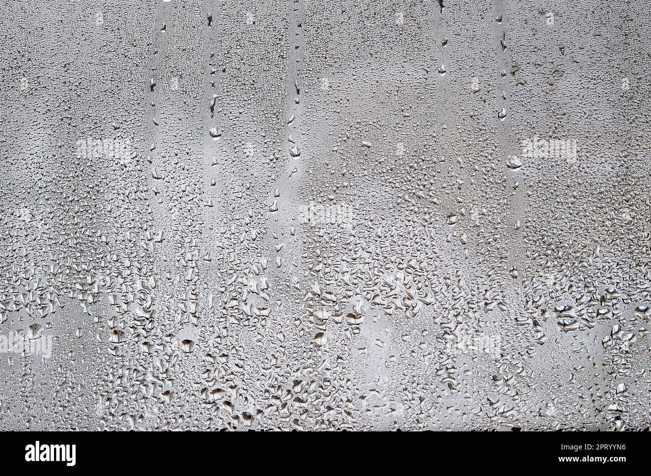 Texture of a drop of rain on a glass wet transparent background. Toned ...