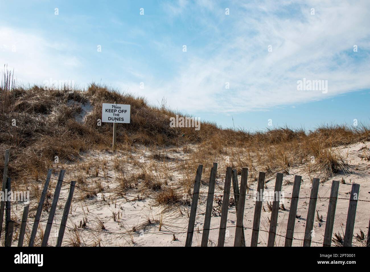 Keep off the dunes sign posted behind a picket fence in the sand dunes ...