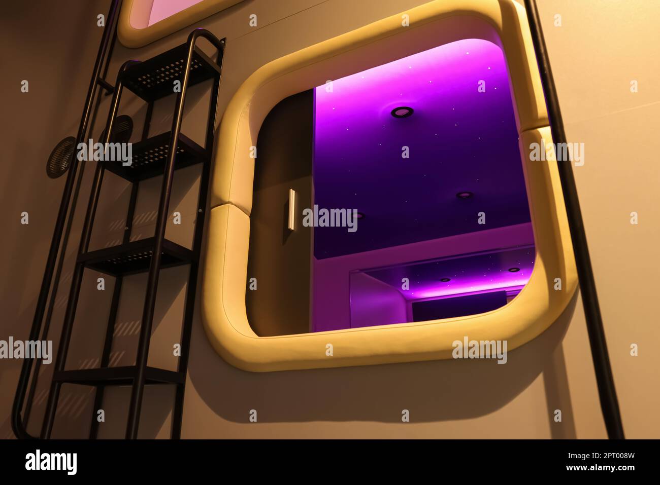 Capsule with purple light in modern pod hostel Stock Photo - Alamy