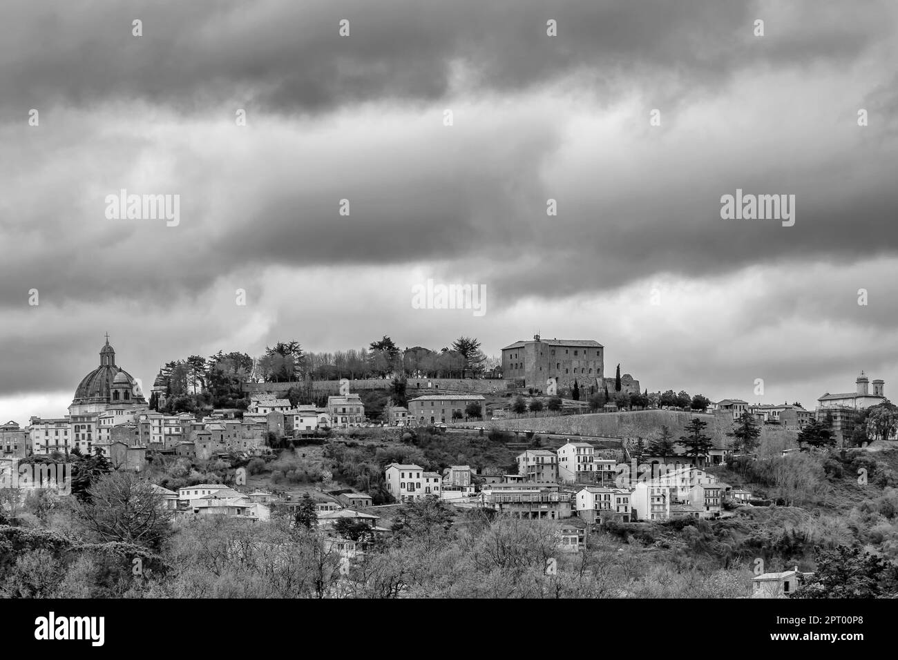 Panoramic black and white view of Montefiascone, Italy under a dramatic ...