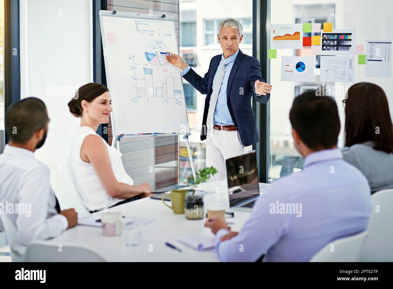 Working together as a team. a businessman giving a presentation to ...