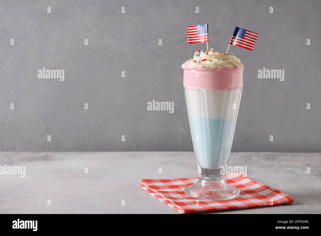 Patriotic milkshake with American flag, whipped cream, red, white and ...