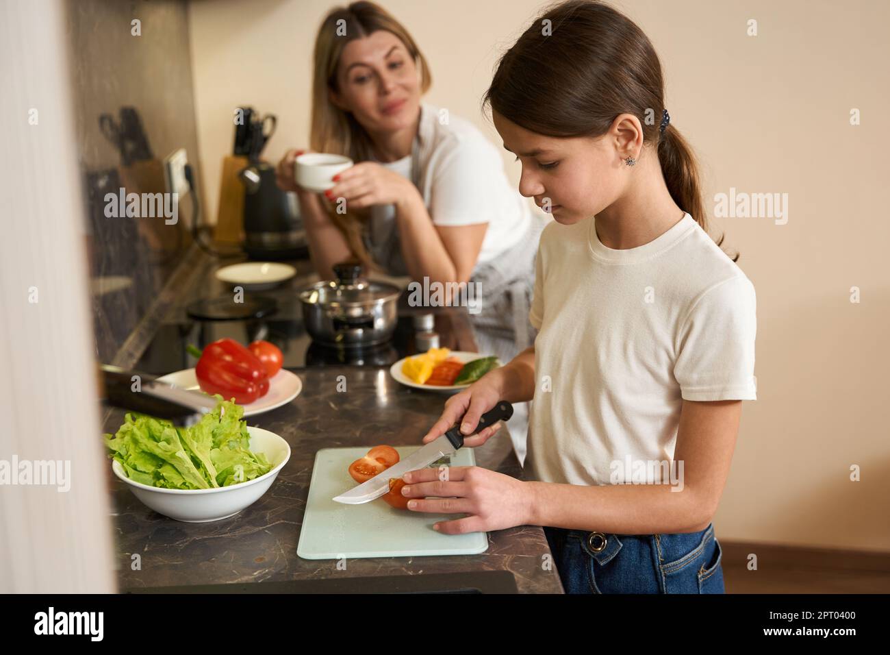 Waist up cute daughter learning to cook breakfast for family Stock ...