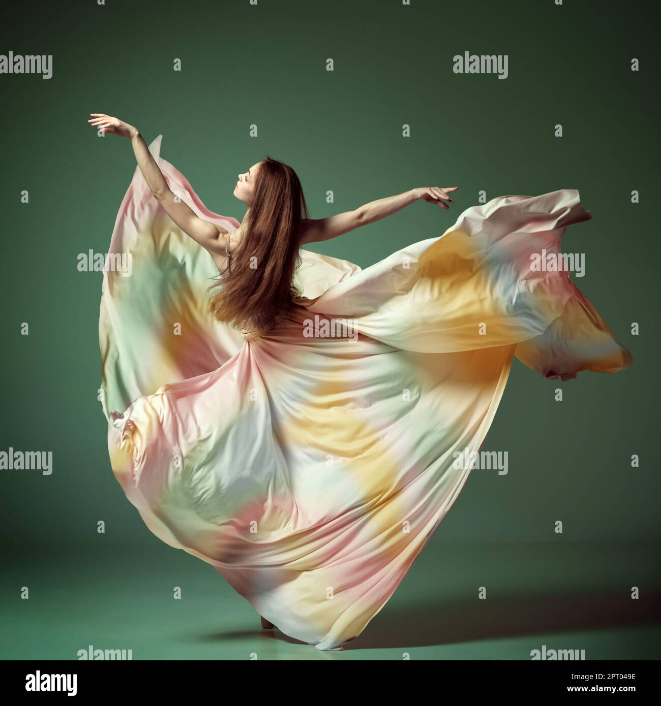 One beautiful ballerina, young girl dancing gracefully with with fabric ...