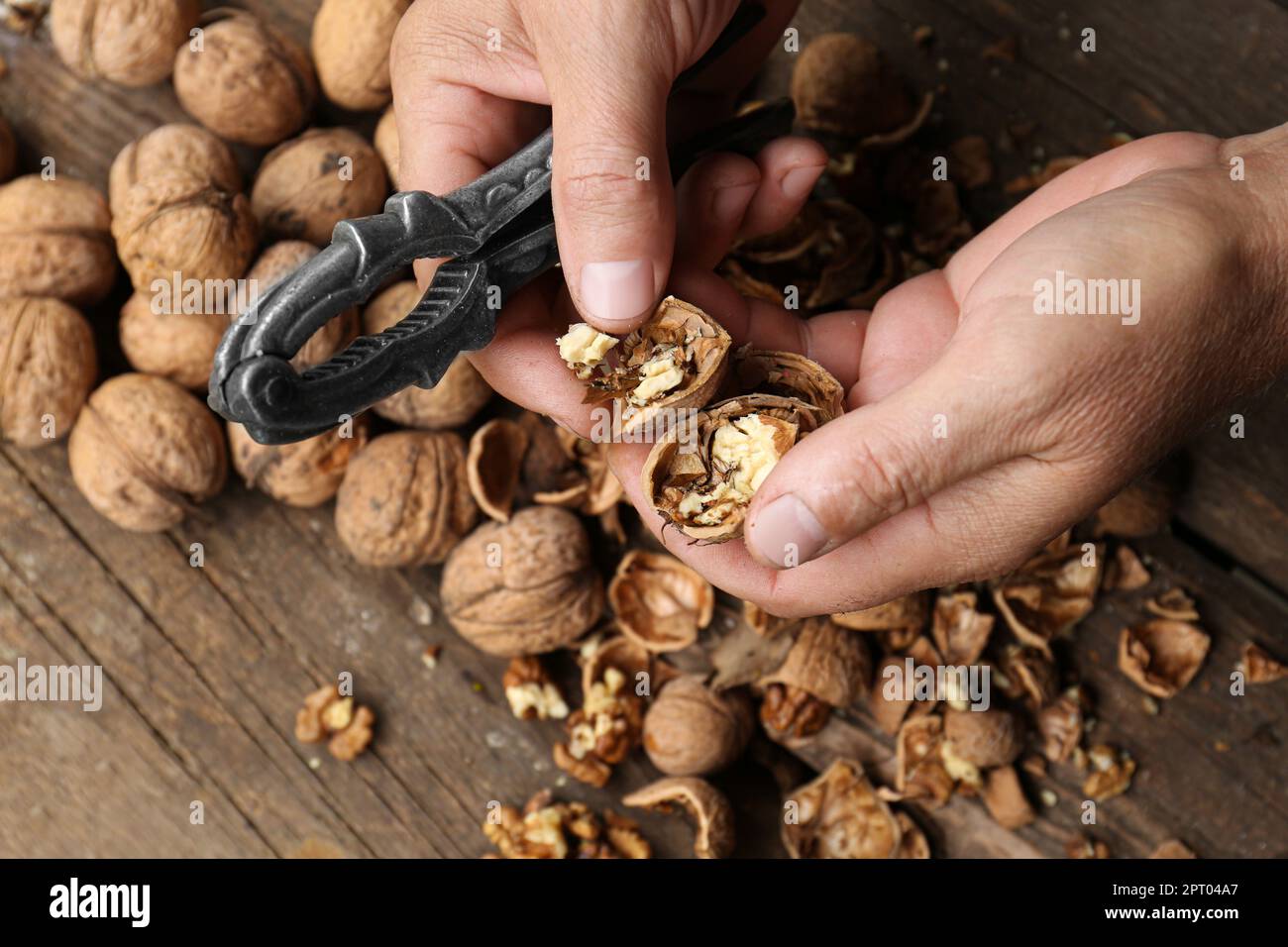 Man cracking walnut nutcracker hi-res stock photography and images - Alamy