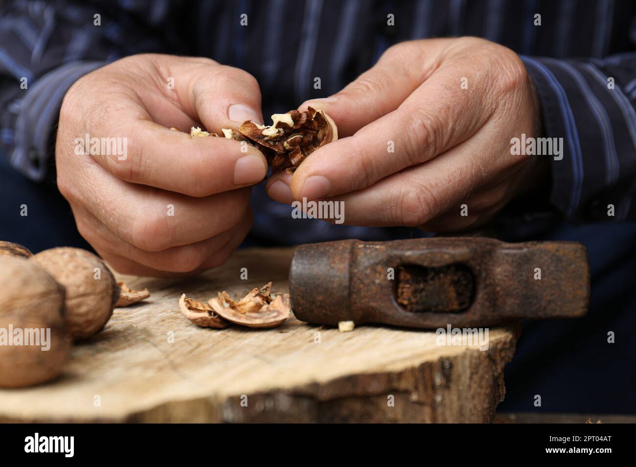 Man cracking walnuts hammer hi-res stock photography and images - Alamy