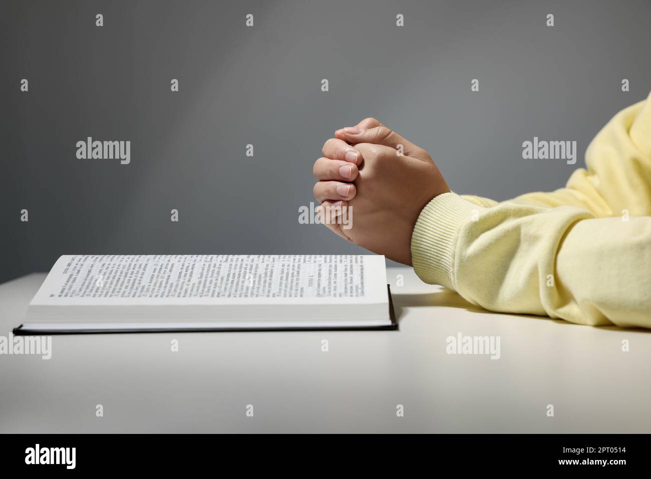 Adult woman praying over grey hi-res stock photography and images - Alamy
