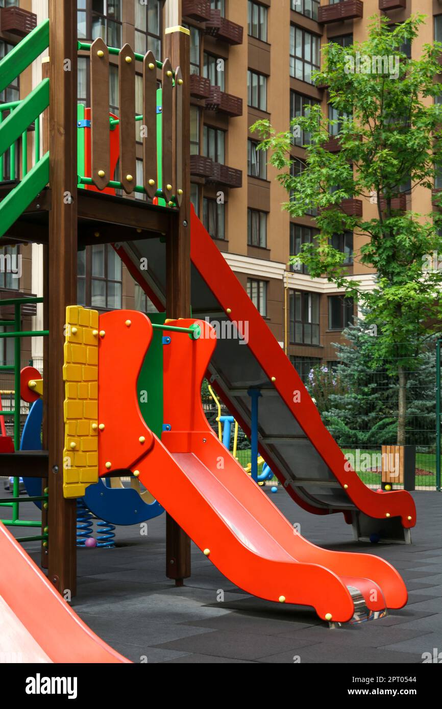 Empty outdoor children's playground with slides in residential area ...