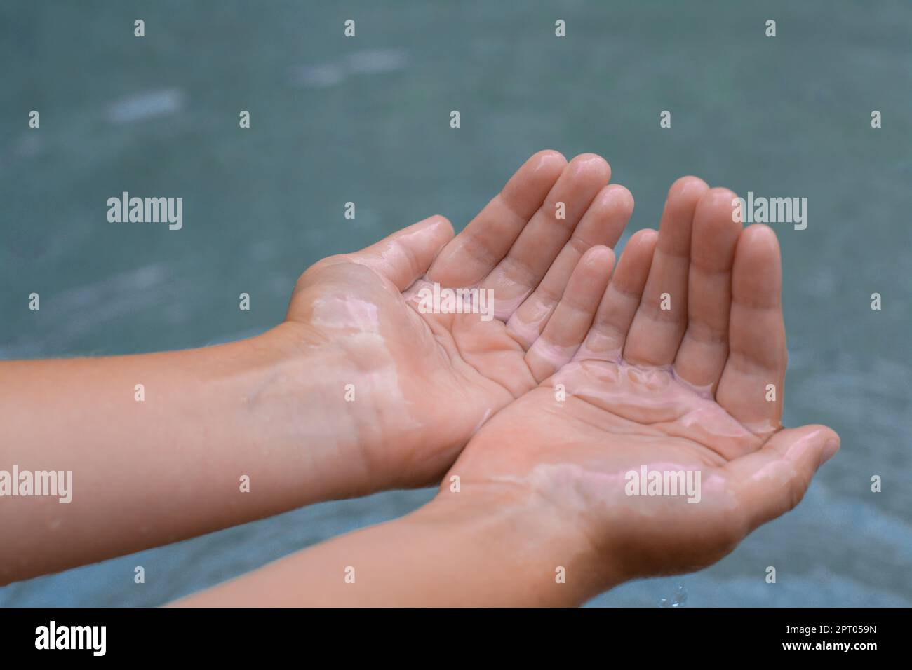 Kid holding water in hands above sea outdoors, closeup Stock Photo - Alamy