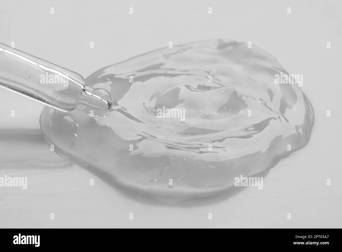 Dripping facial gel from pipette on white background, closeup Stock ...