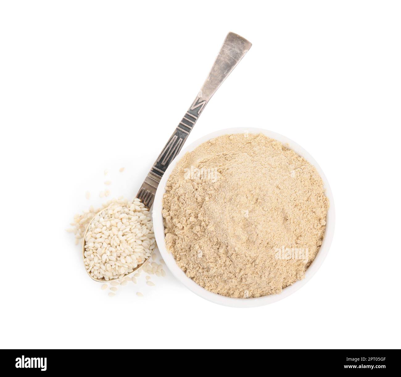 Sesame flour in ceramic bowl and spoon of seeds isolated on white, top ...