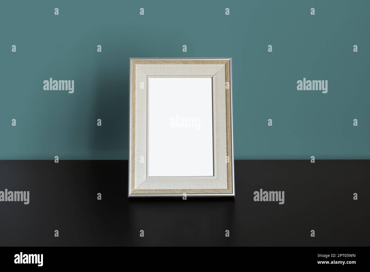 Picture frame mockup on emerald green wall Stock Photo - Alamy