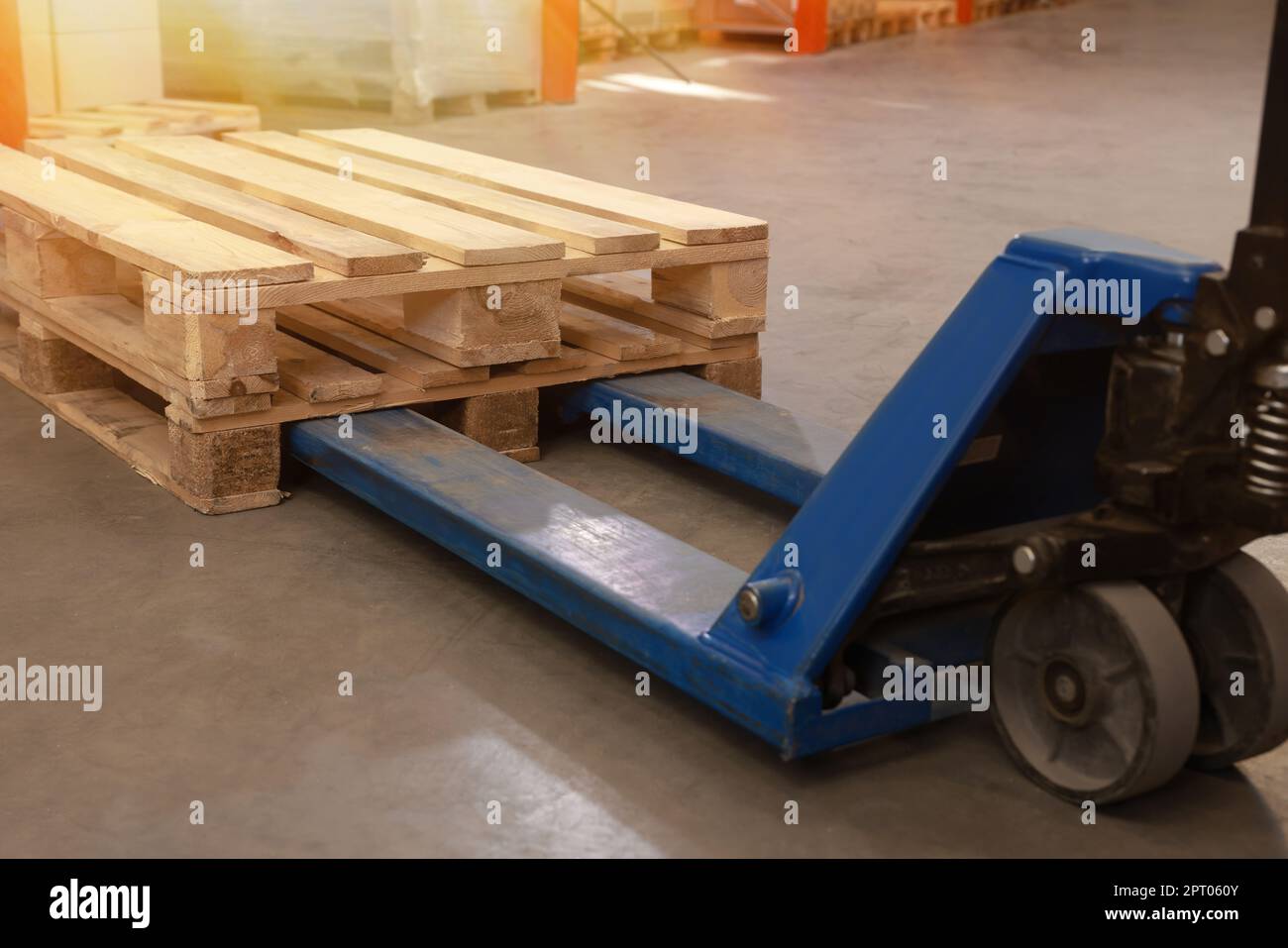 Modern manual forklift with wooden pallets in warehouse, closeup Stock ...