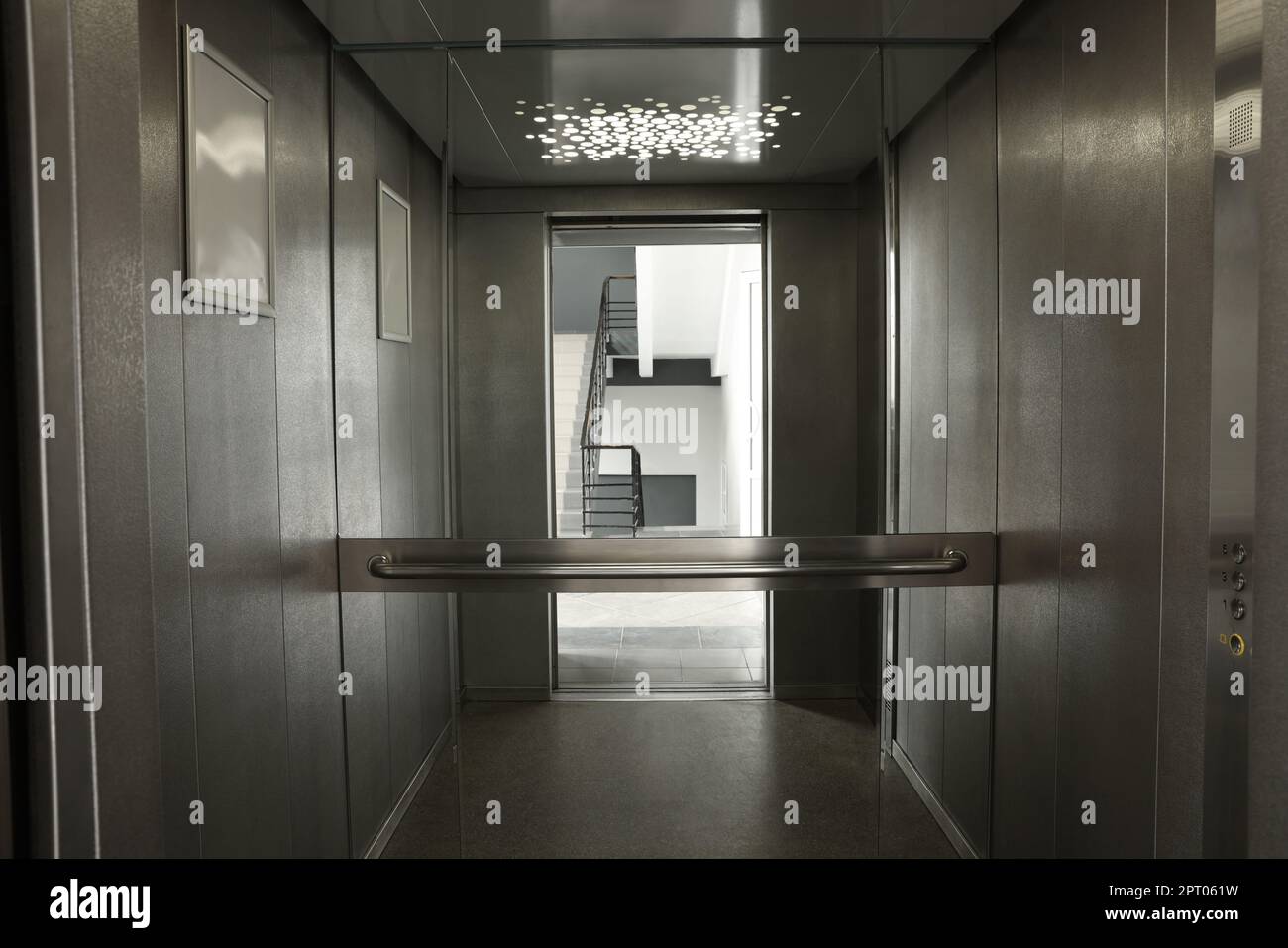 Open elevator`s cabin with big mirror indoors Stock Photo - Alamy