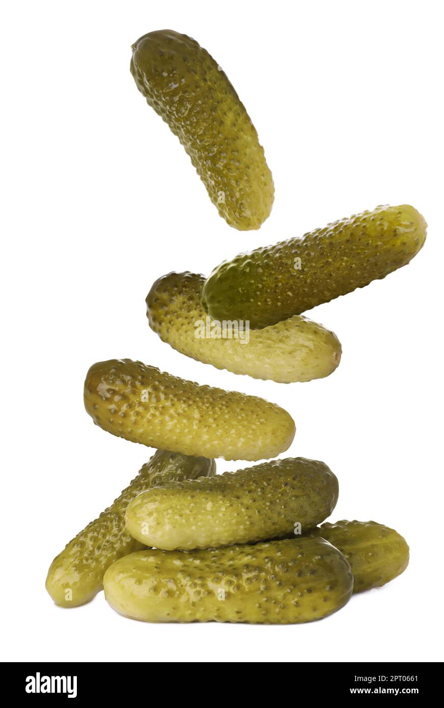 Tasty pickled cucumbers falling into pile on white background Stock ...