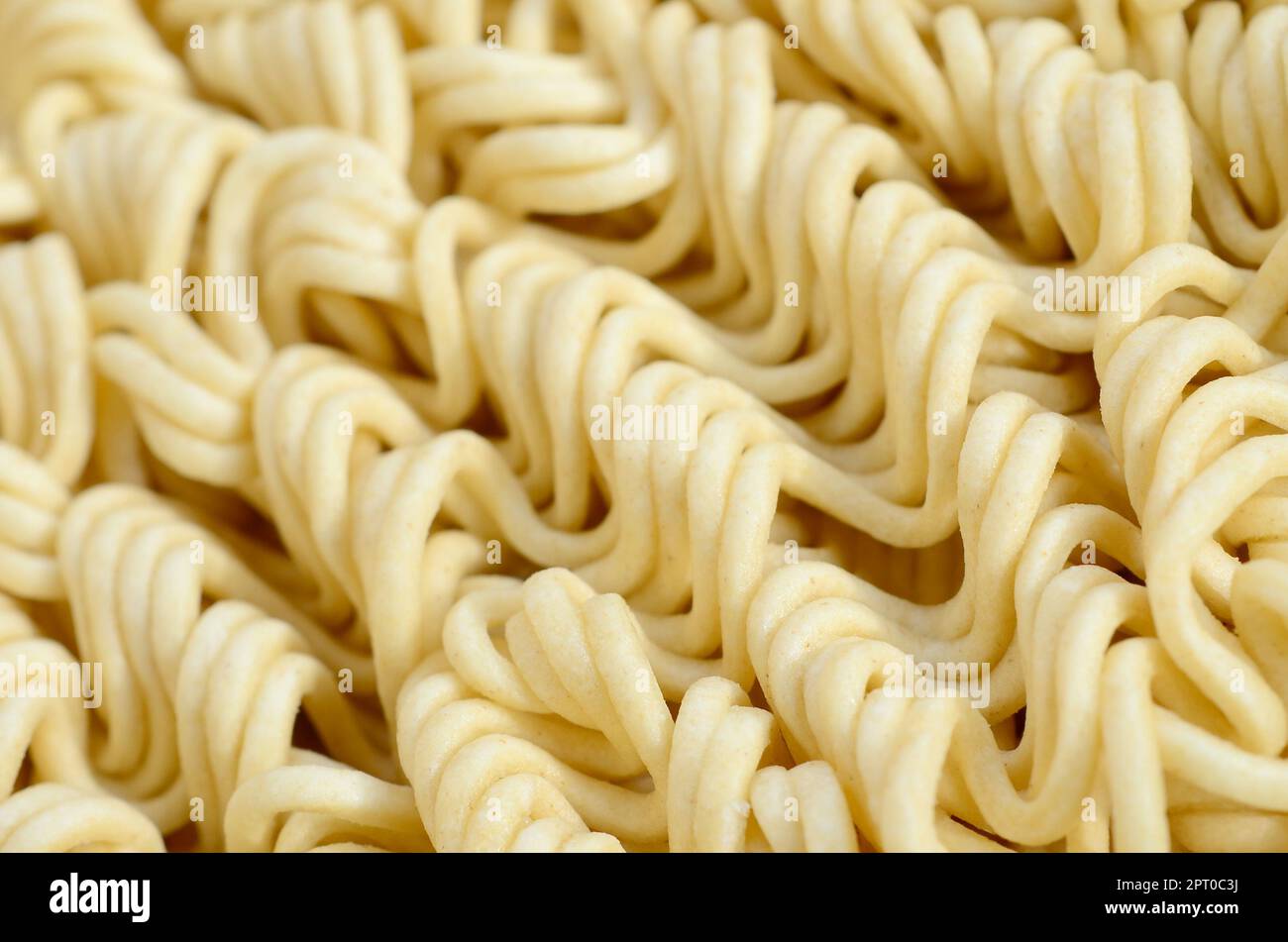 Close up view of yellow dry instant noodles. Chinese traditional food ...