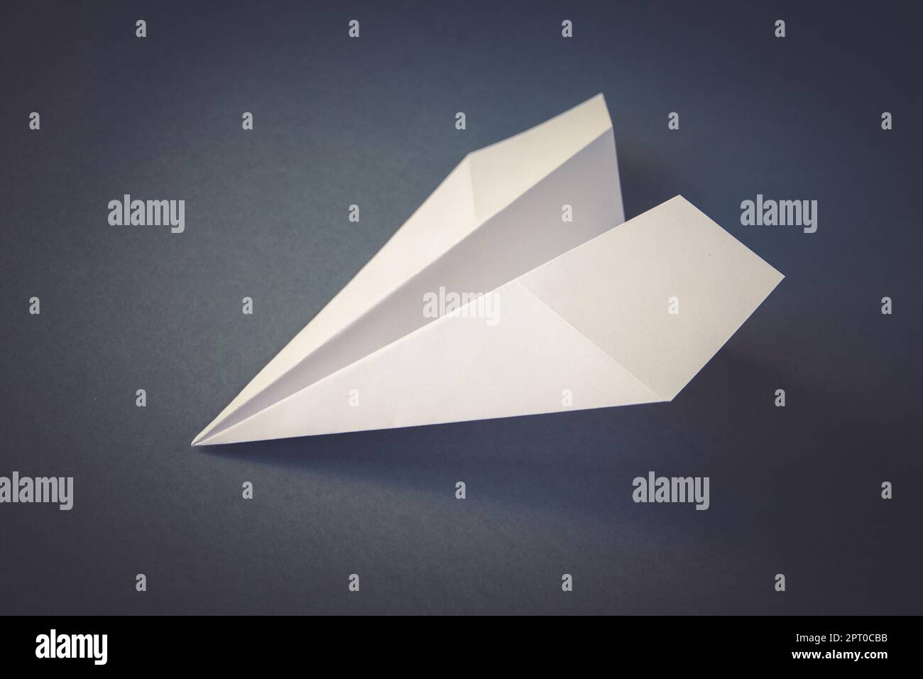 White paper plane origami isolated on a blank grey background Stock ...
