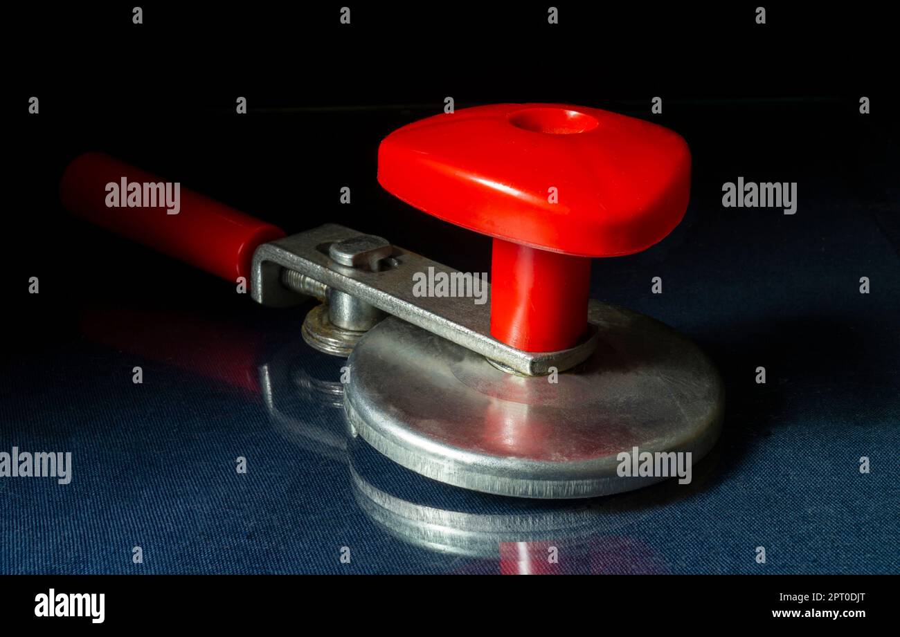 Manual mechanism with red handle on black background.rolling machine ...